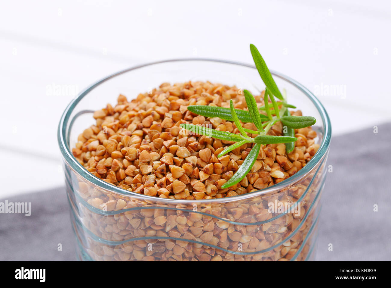glass of raw buckwheat on grey place mat - close up Stock Photo - Alamy