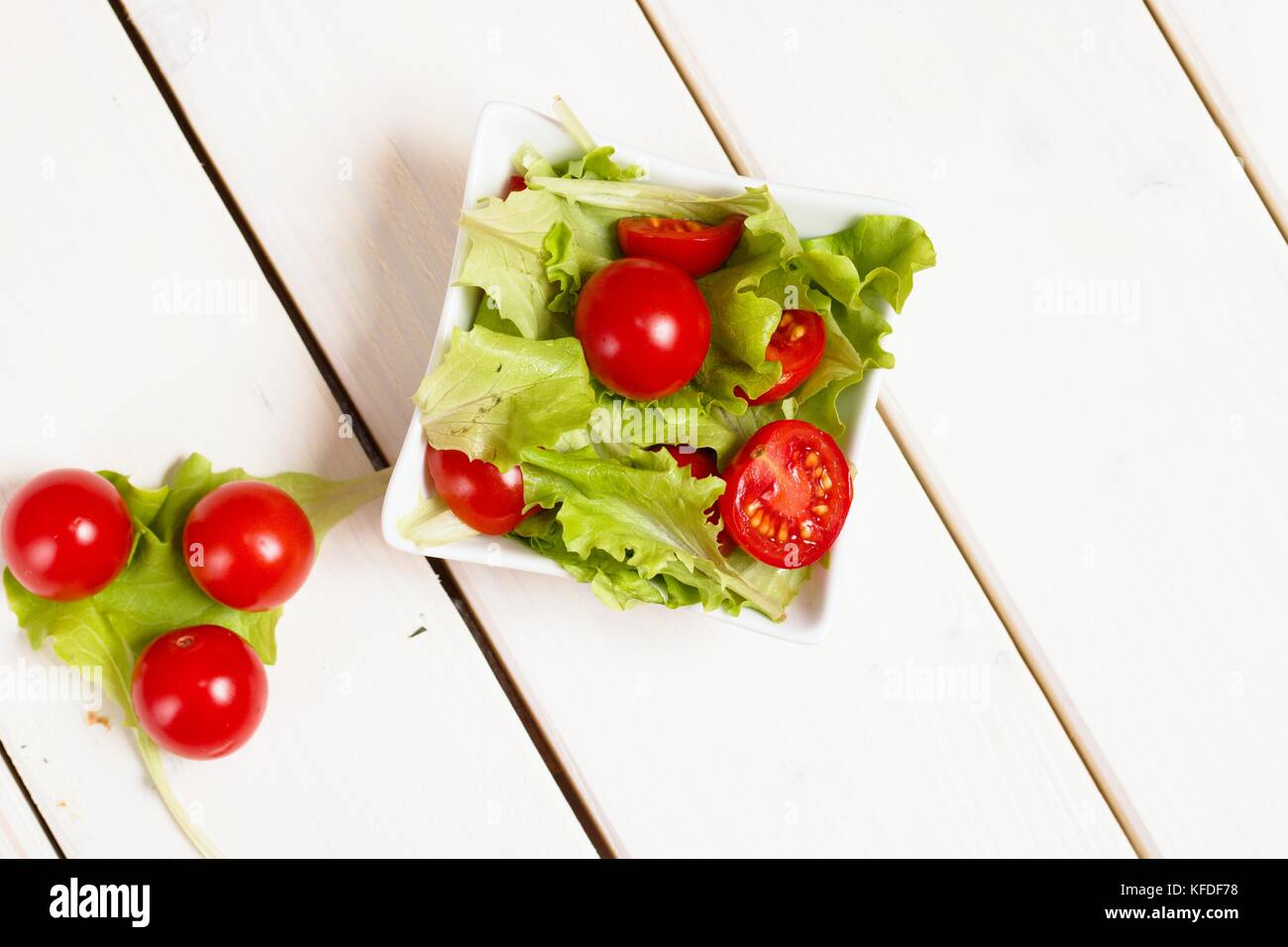 Top down view of bowl of cherry tomatoes and lettuce salad Stock Photo ...