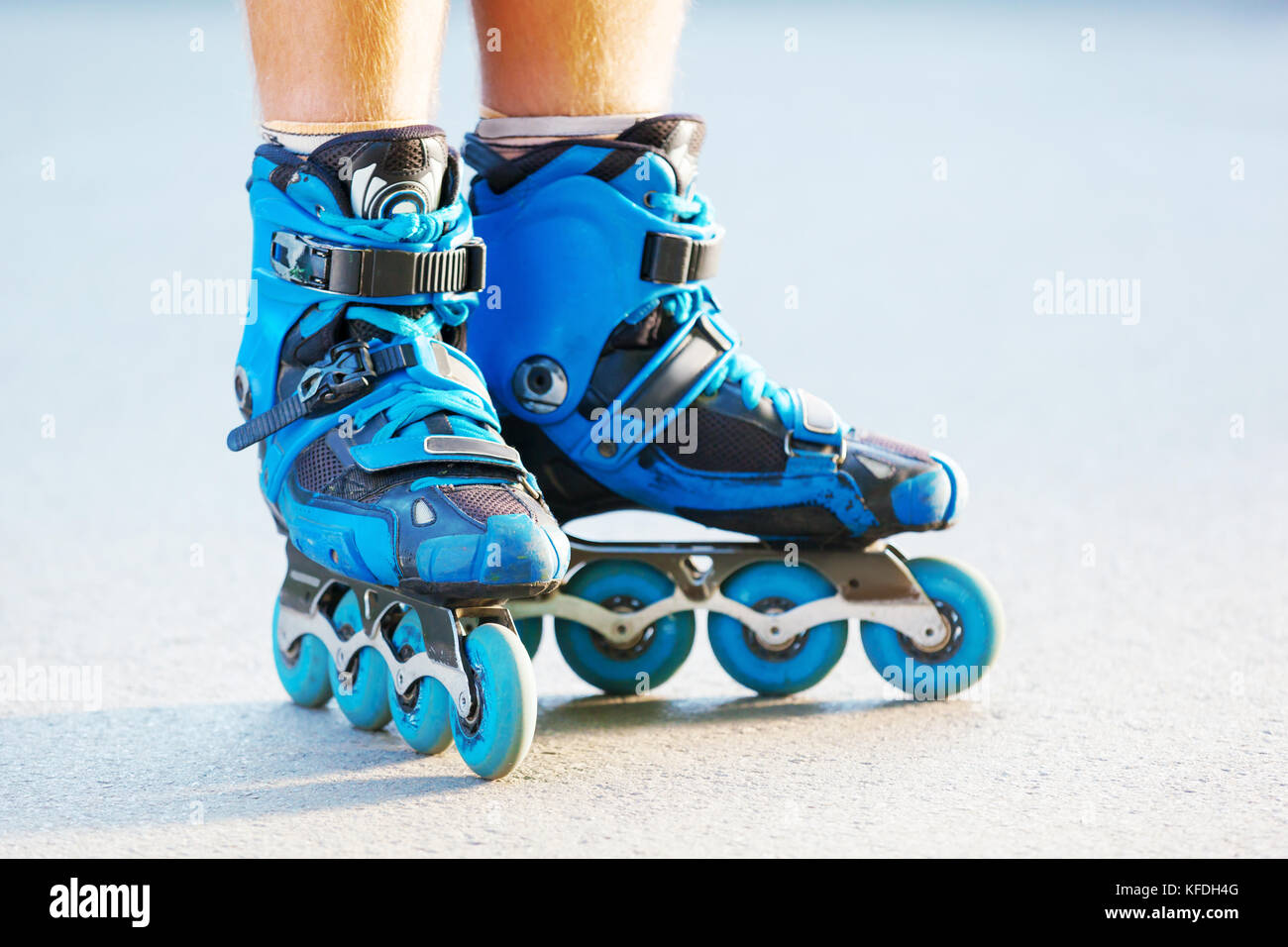 Close up photo of legs in blue inline skates standing Stock Photo - Alamy