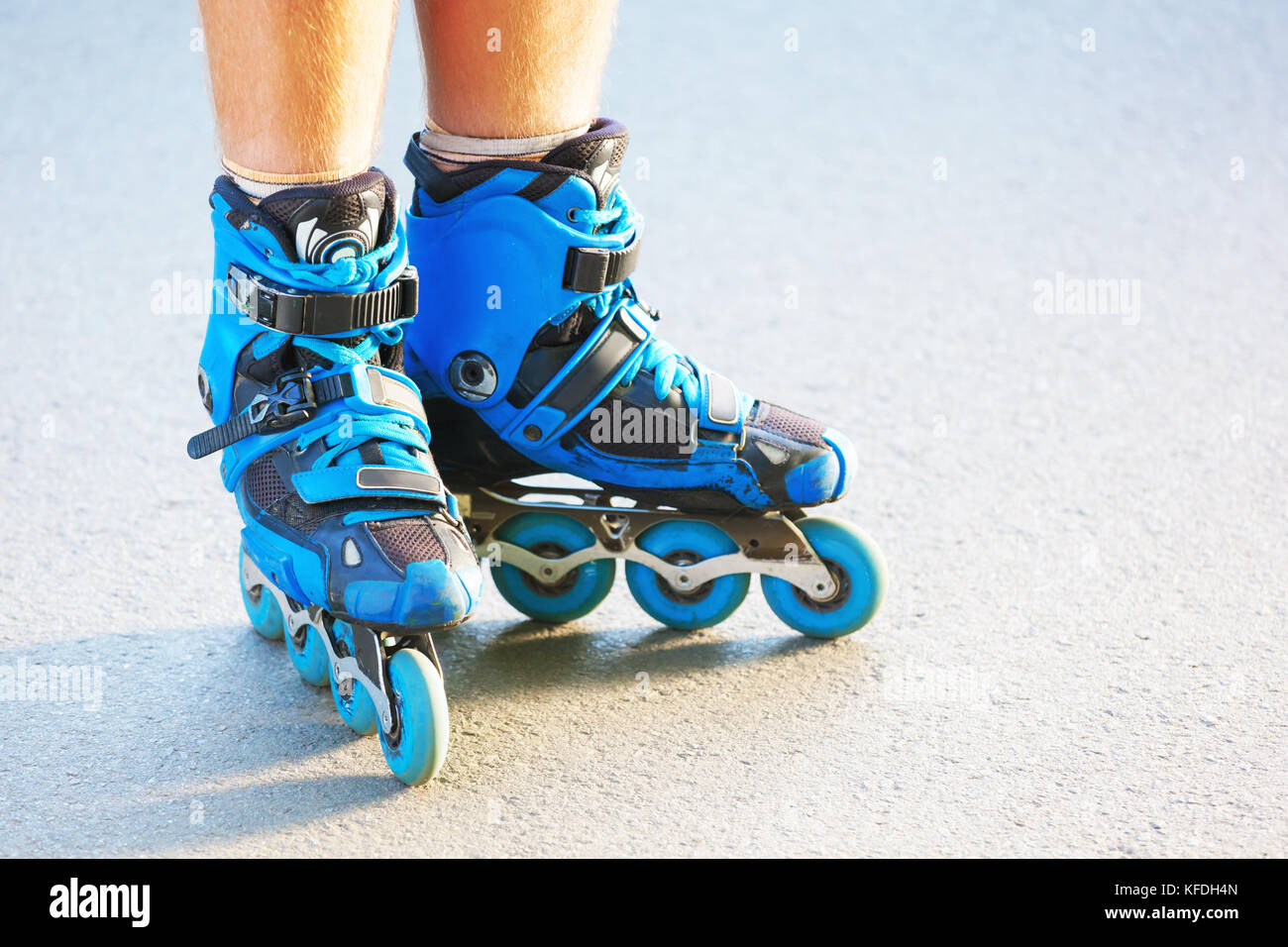 Close up photo of legs in blue inline skates standing Stock Photo - Alamy