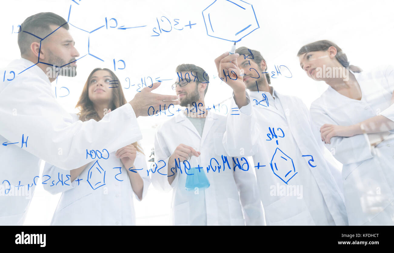 view through the transparent Board. a group of scientists analyze ...