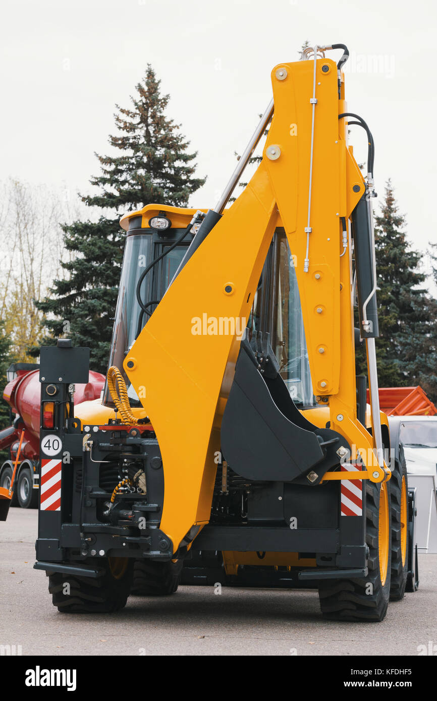Yellow road constructor tractor - rear view Stock Photo - Alamy