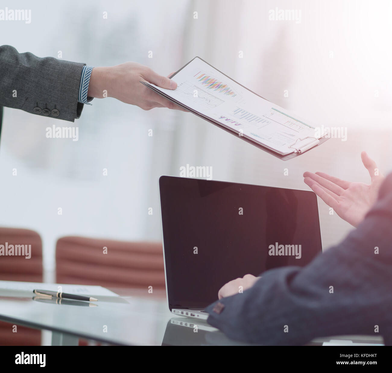 Businessman giving document to his colleague at meeting Stock Photo - Alamy