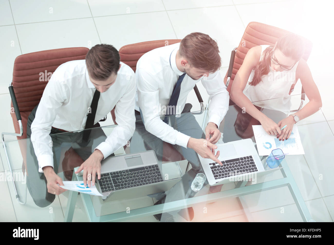 Photo of a young business team working in a modern office. Top view ...