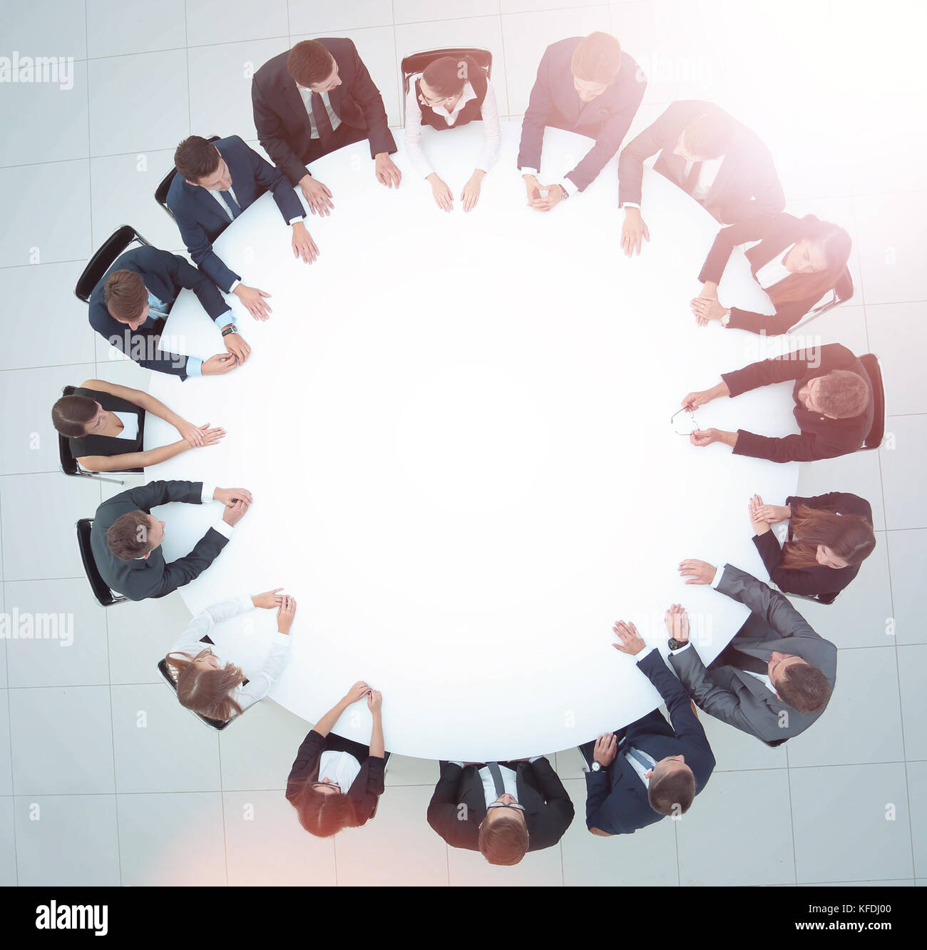 Top view of smilimg business team, sitting at a round table on white ...