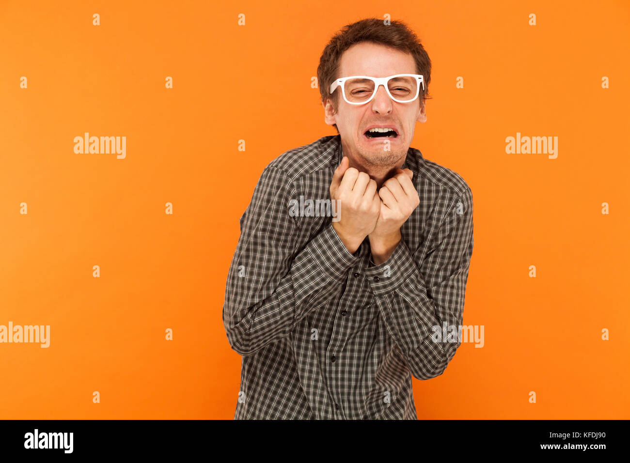 Emotional man crying. Studio shot. Isolated on orange background Stock ...
