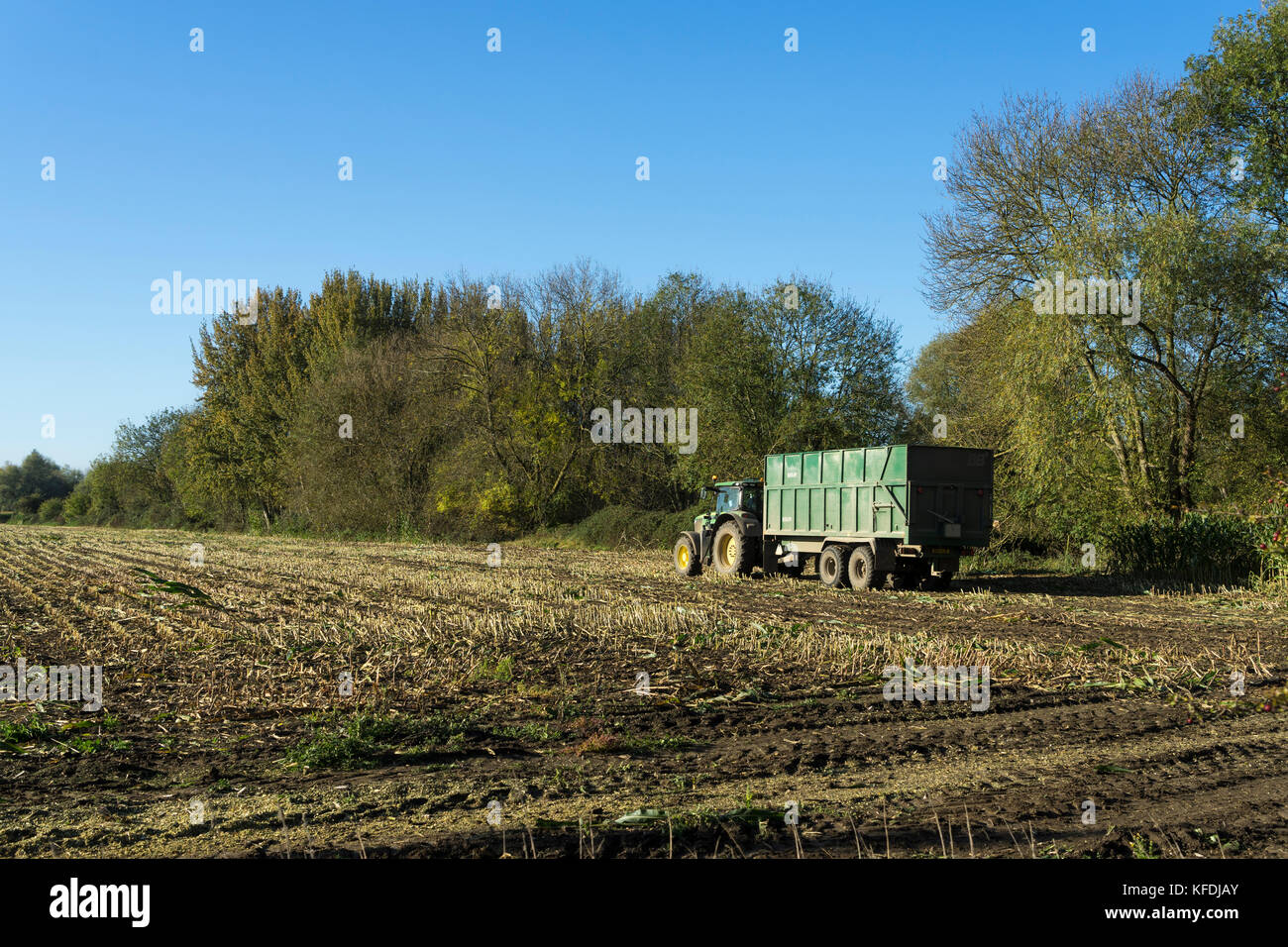 farm tractor and trailer crossing harvested field Stock Photo - Alamy