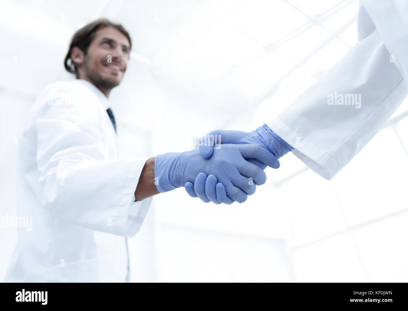 Doctors handshake as partnership or teamwork Medical team hand shake as ...