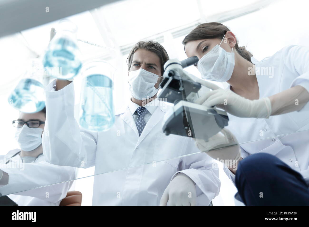 Male researcher looking through microscope hi-res stock photography and ...