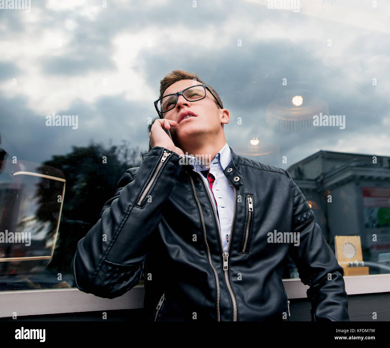 man in the jacket on the street talking on a cell phone Stock Photo - Alamy