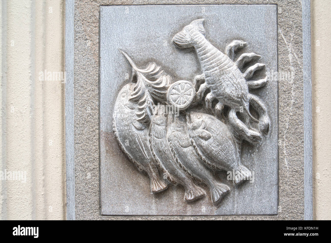 White bas-relief figure of a fish and a lobster. The horizontal frame ...