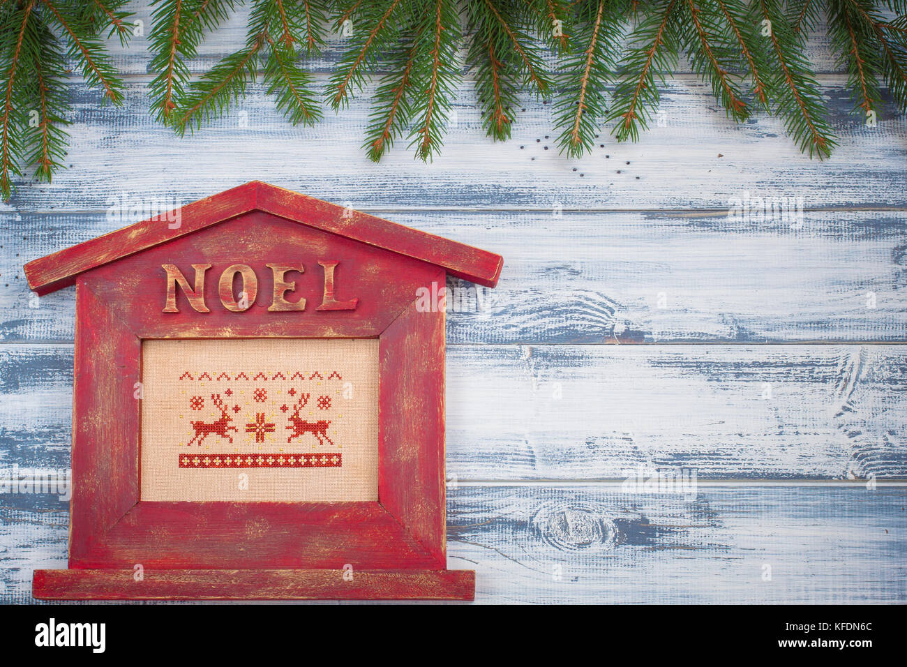 Noel house shaped frame with branches of Christmas-tree on old wooden ...