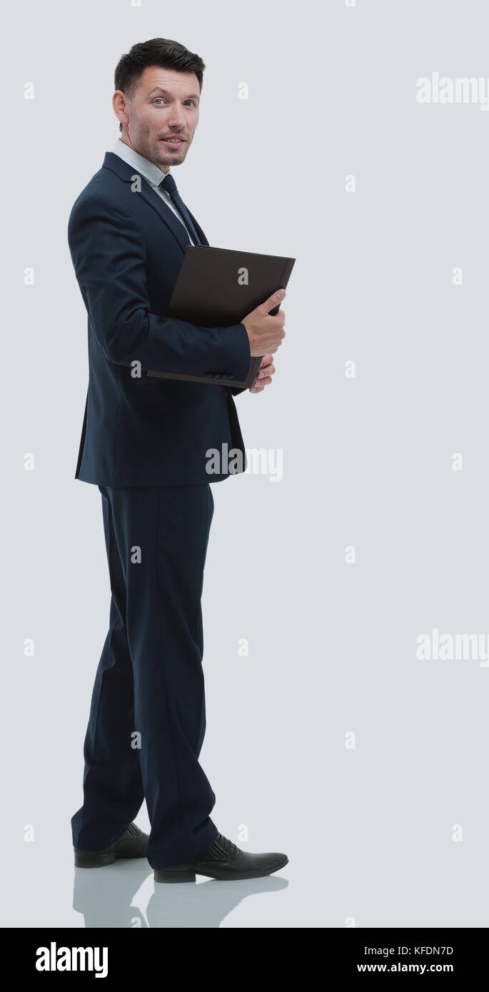 Full length business man looking at camera and standing sideways ...