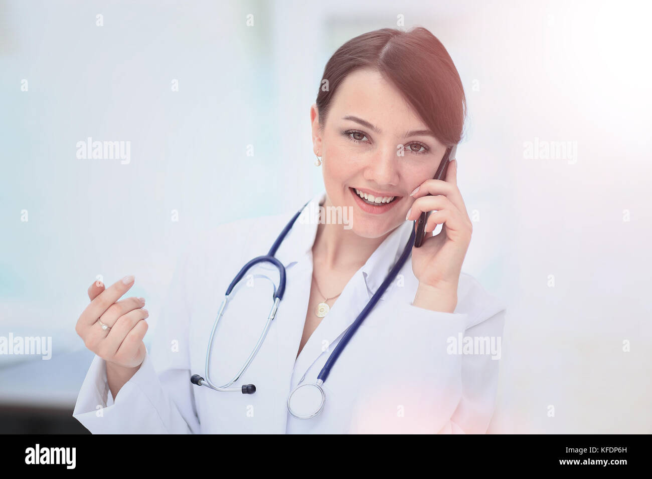 Doctor talking on telephone Stock Photo - Alamy