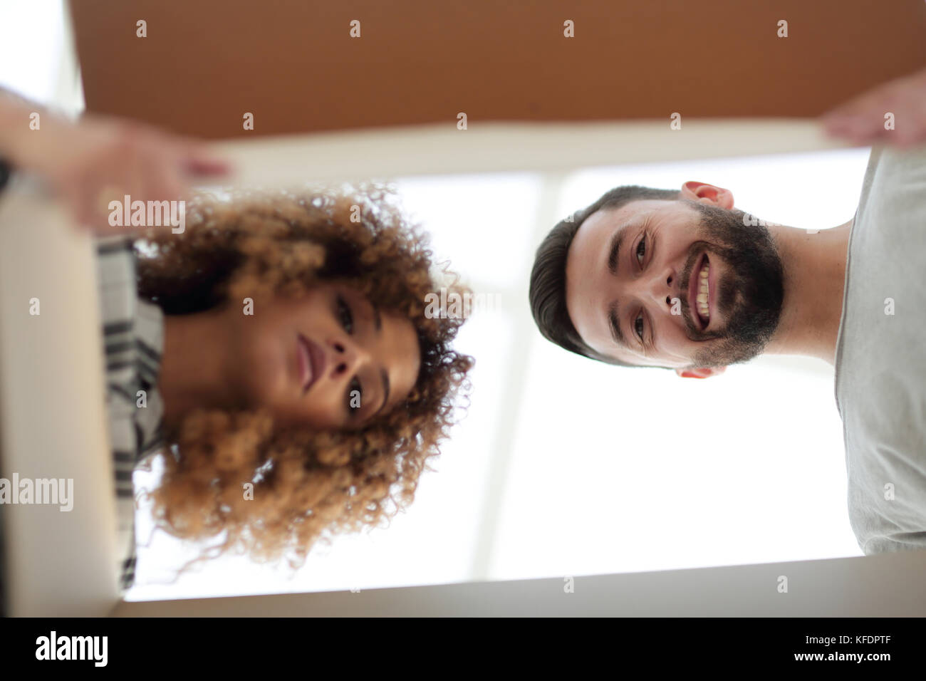 View from below a young couple looking inside the box. Photo with copy ...
