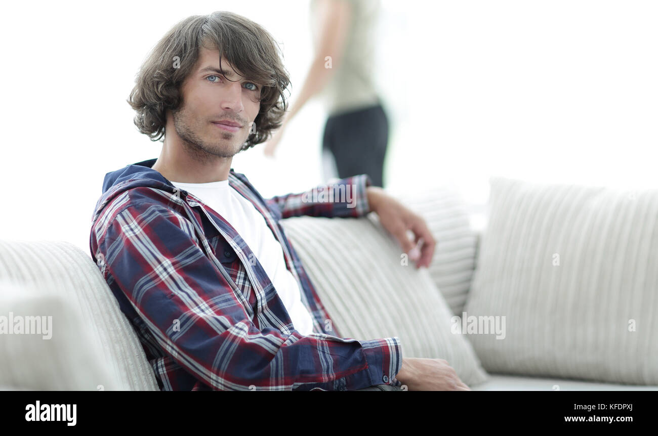 handsome successful guy sitting on the couch. photo with copy space ...