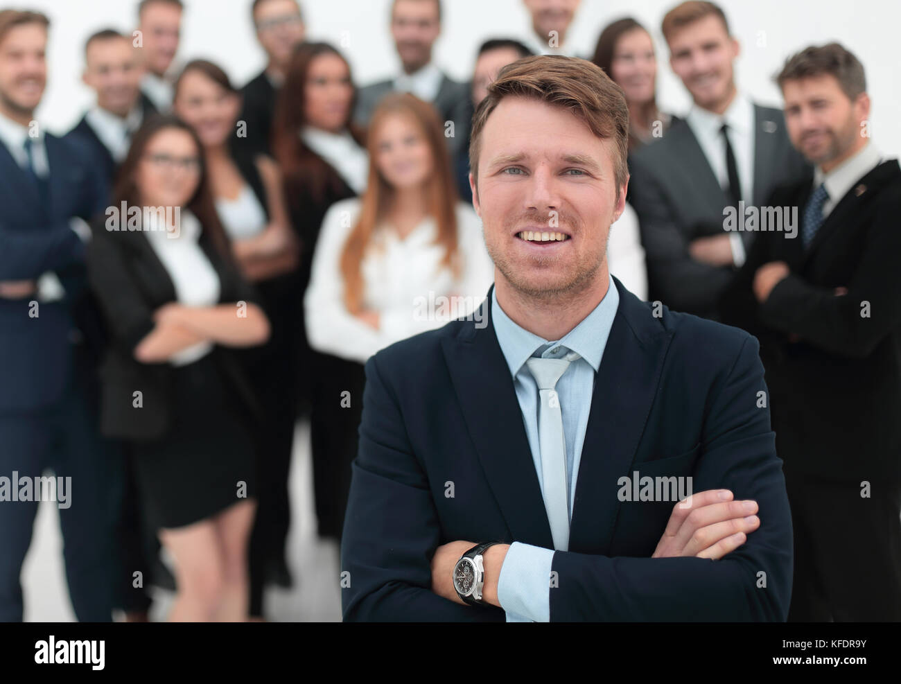 confident businessman standing in front of a large business team Stock ...