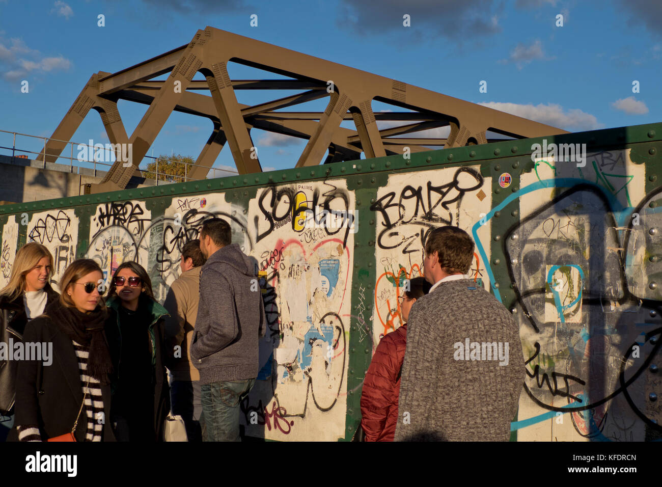 People walk past wall with graffiti in Brick Lane, London,UK Stock ...
