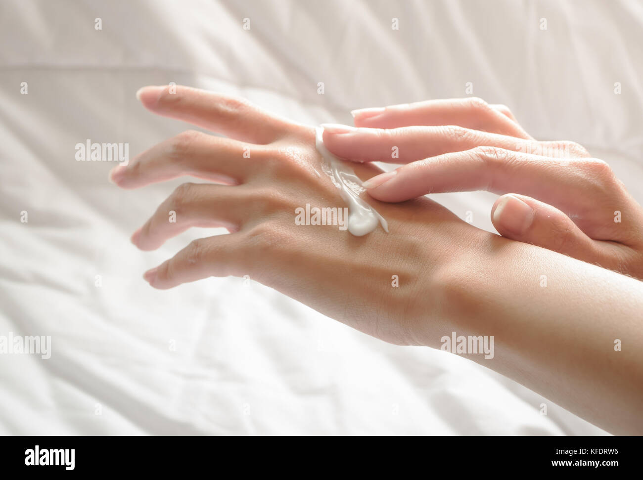 Woman applying lotion arm hi-res stock photography and images - Alamy