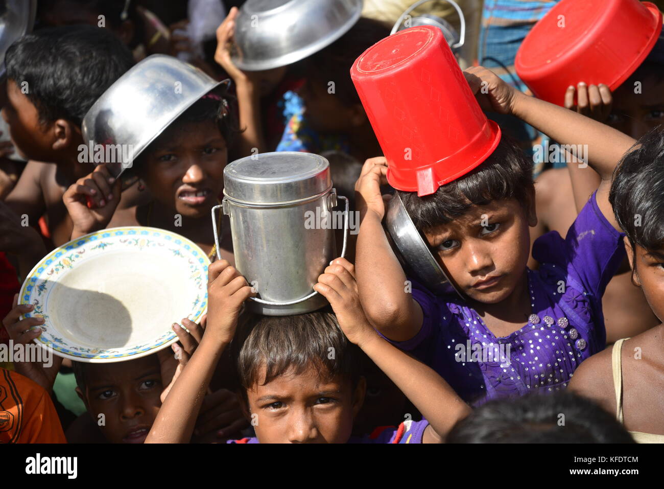 Rohingya refugee children wait to collect food at the palongkhali ...