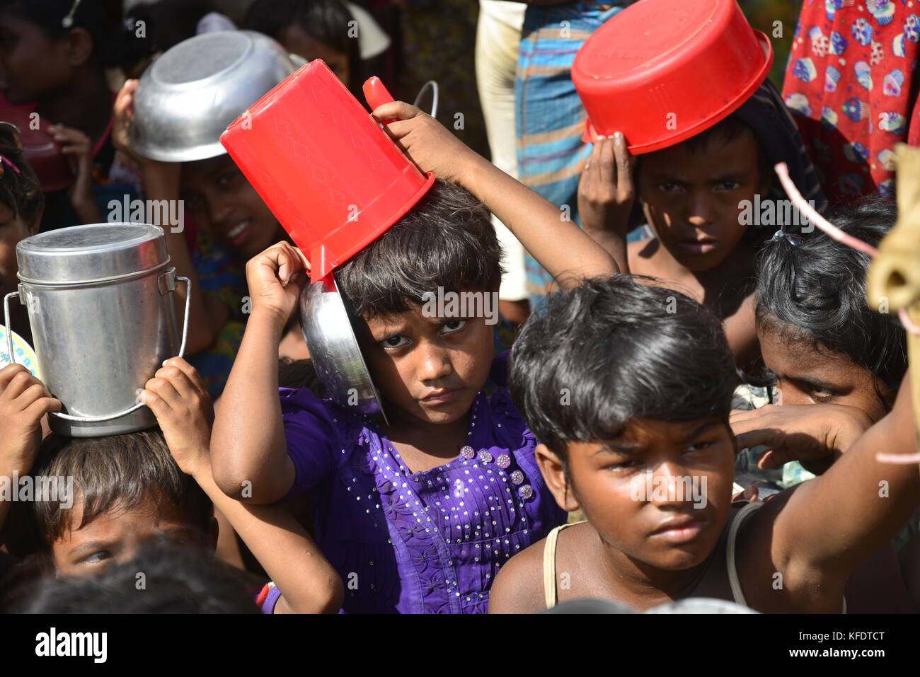 Rohingya refugee children wait to collect food at the palongkhali ...