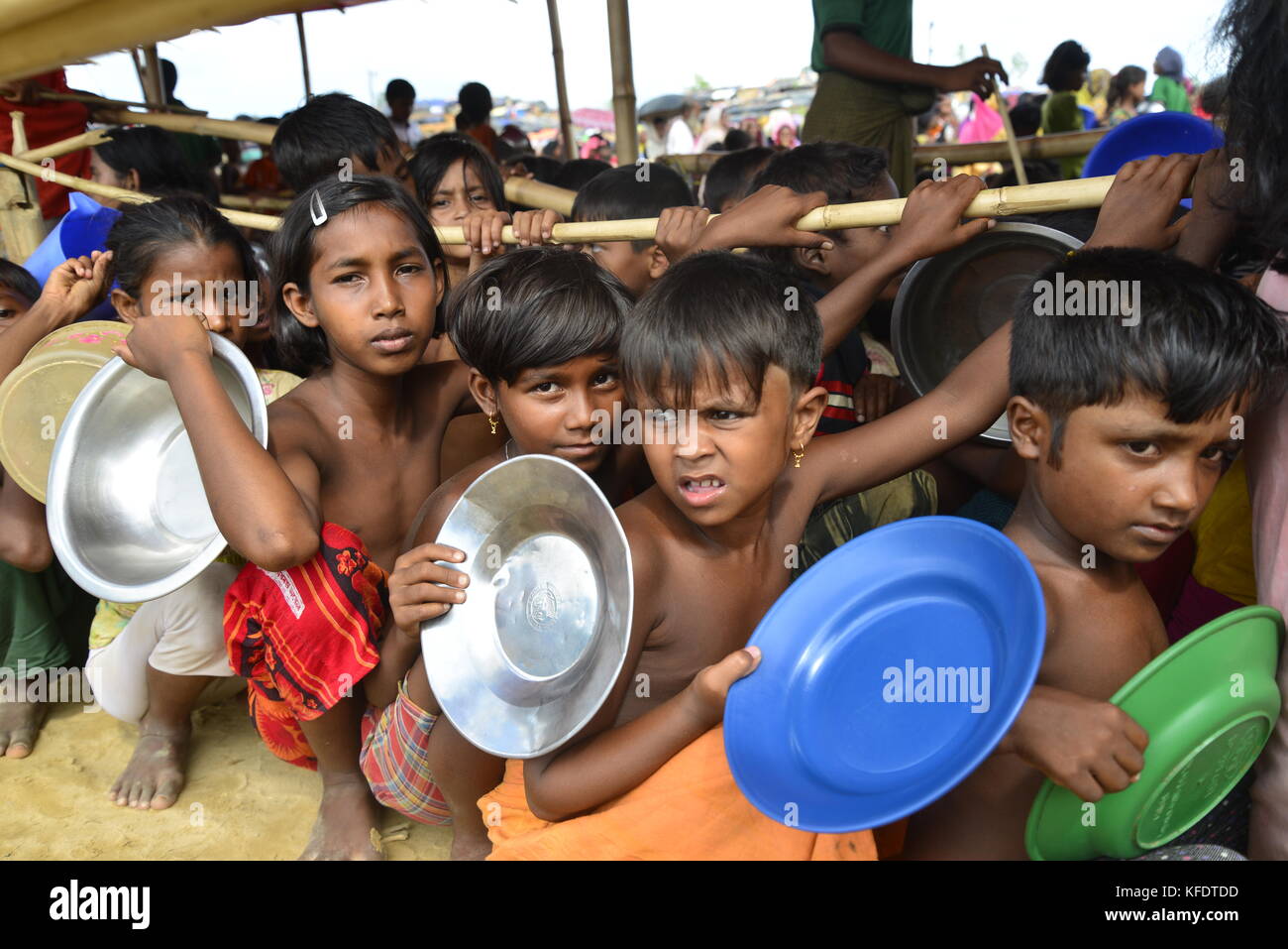 Rohingya refugee children wait to collect food at the palongkhali ...