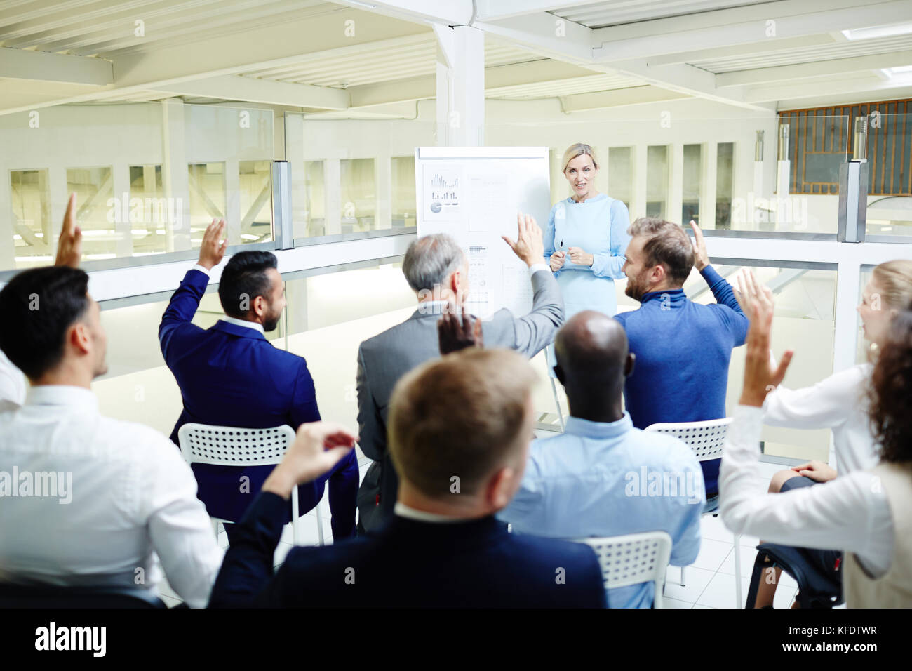 Class teacher raising hands hi-res stock photography and images - Alamy