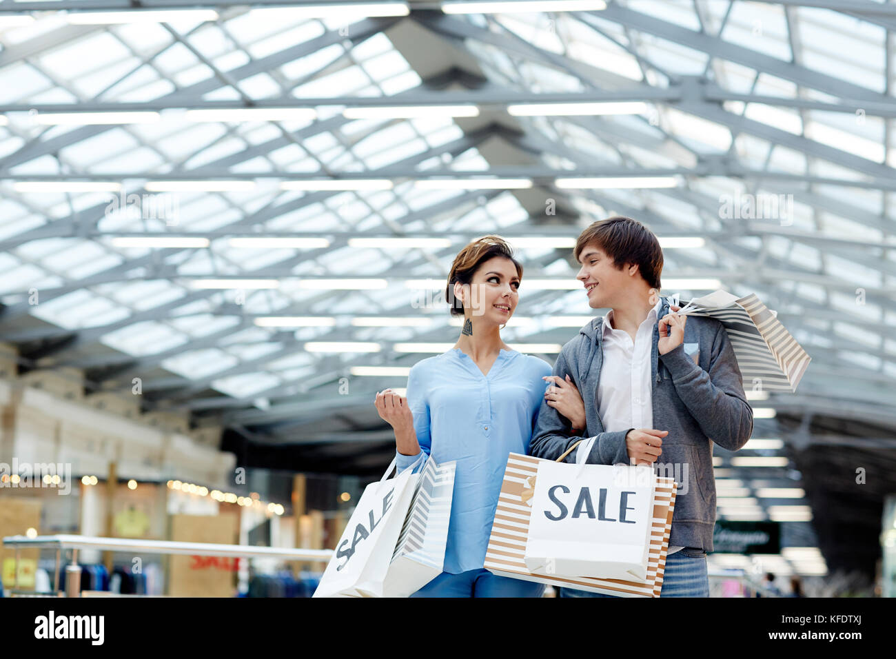Amorous dates with shopping-bags talking during sale on weekend Stock ...