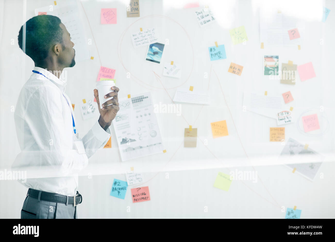 Profile view of pensive African American manager standing at marker ...