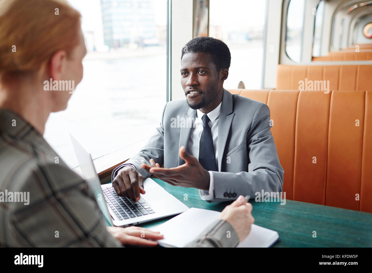 Multi-ethnic team of talented managers gathered together at middle deck ...