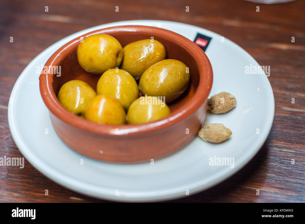 plate of green olives with bone in a white plate Stock Photo - Alamy