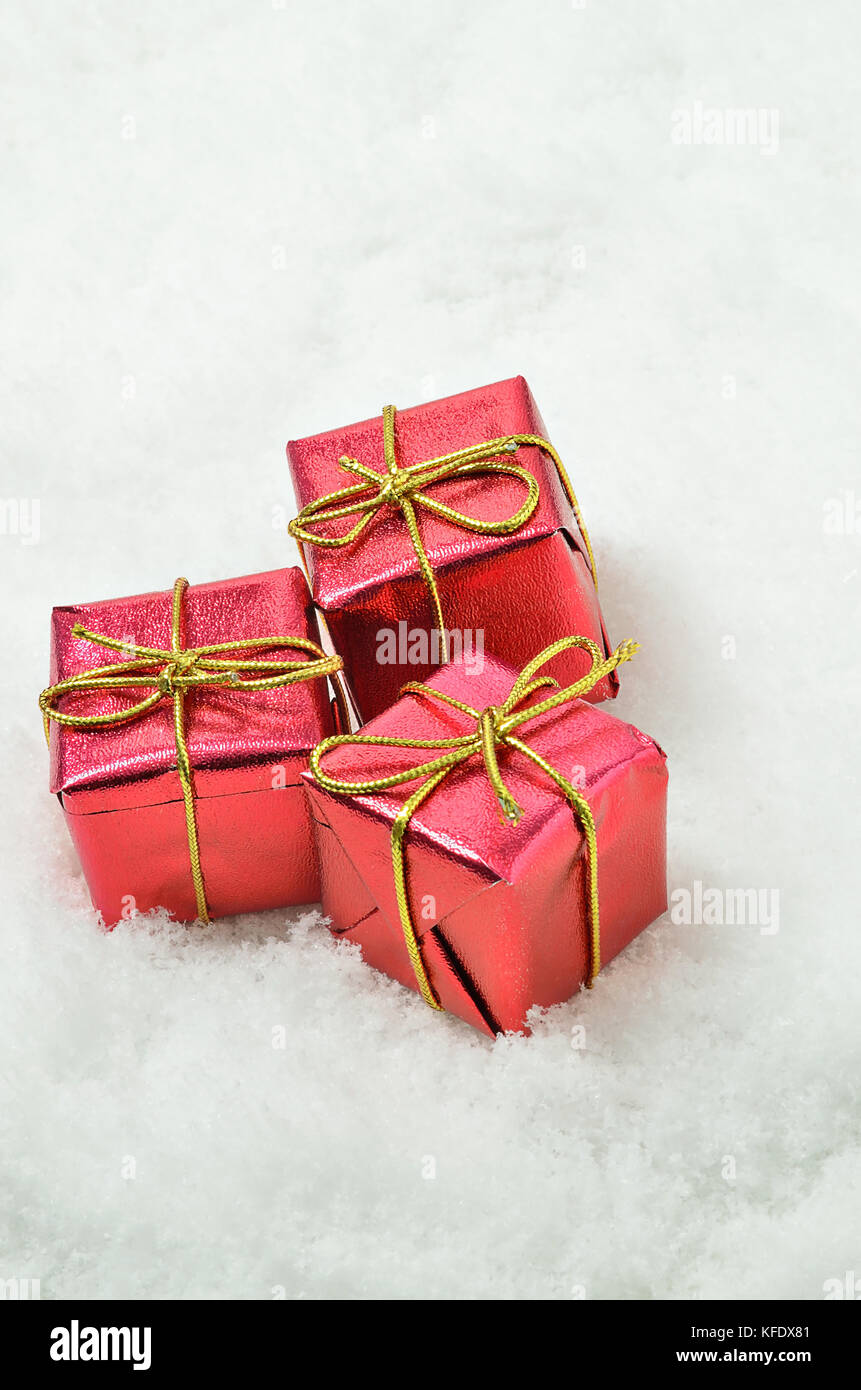 three red parcels on snow background, close up, macro, vertical Stock ...