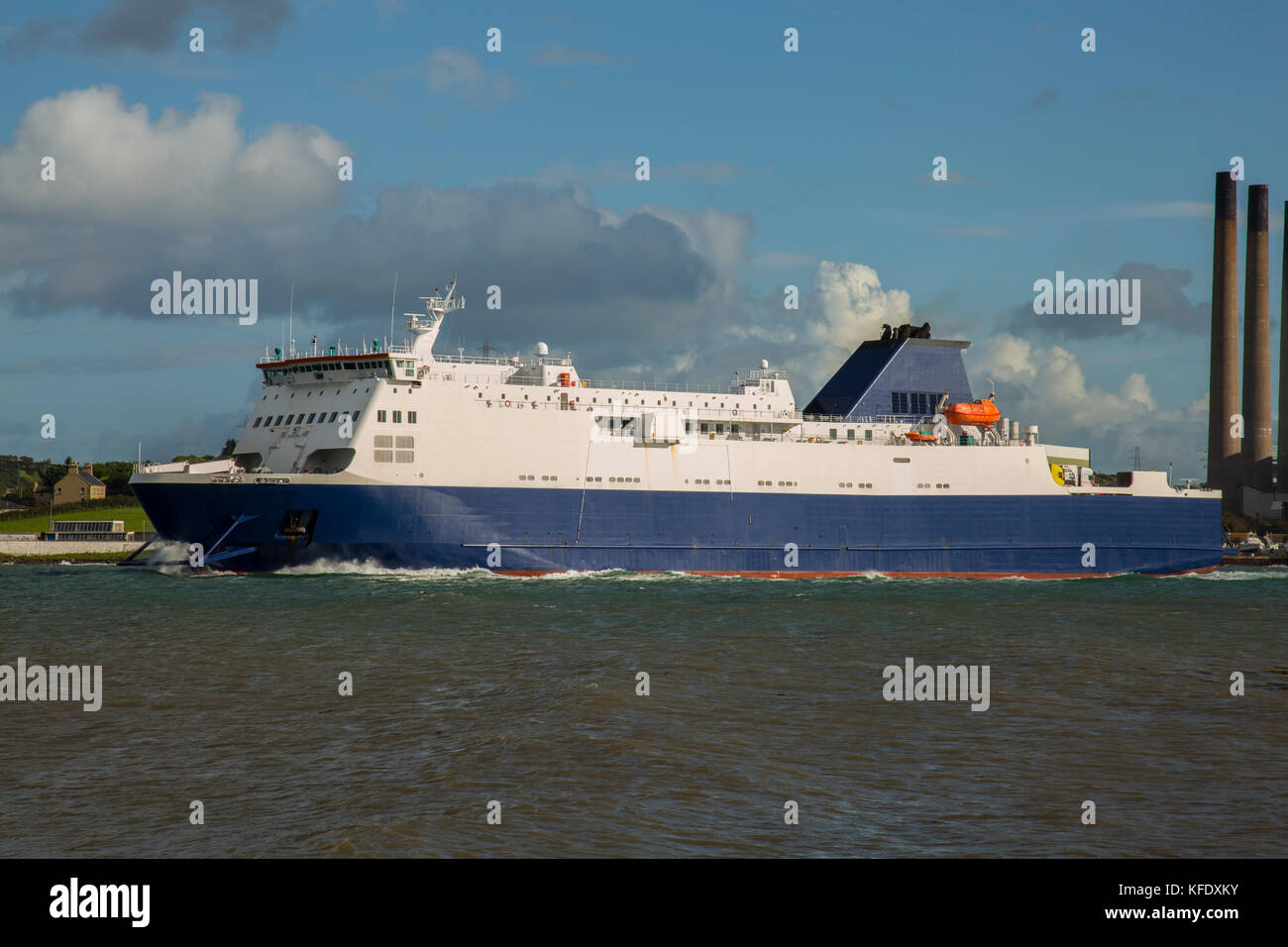 Blue and white ferry sailing under a dramatic sky Stock Photo - Alamy