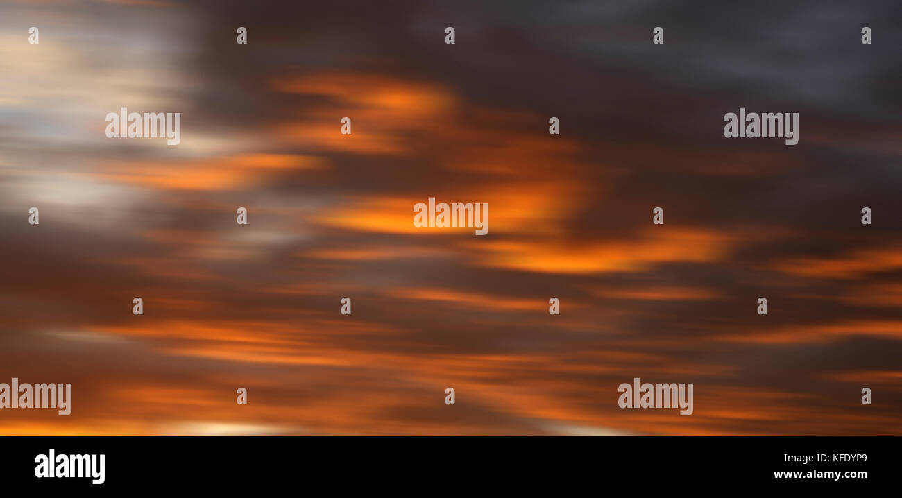 Fast moving clouds at sunset Stock Photo - Alamy