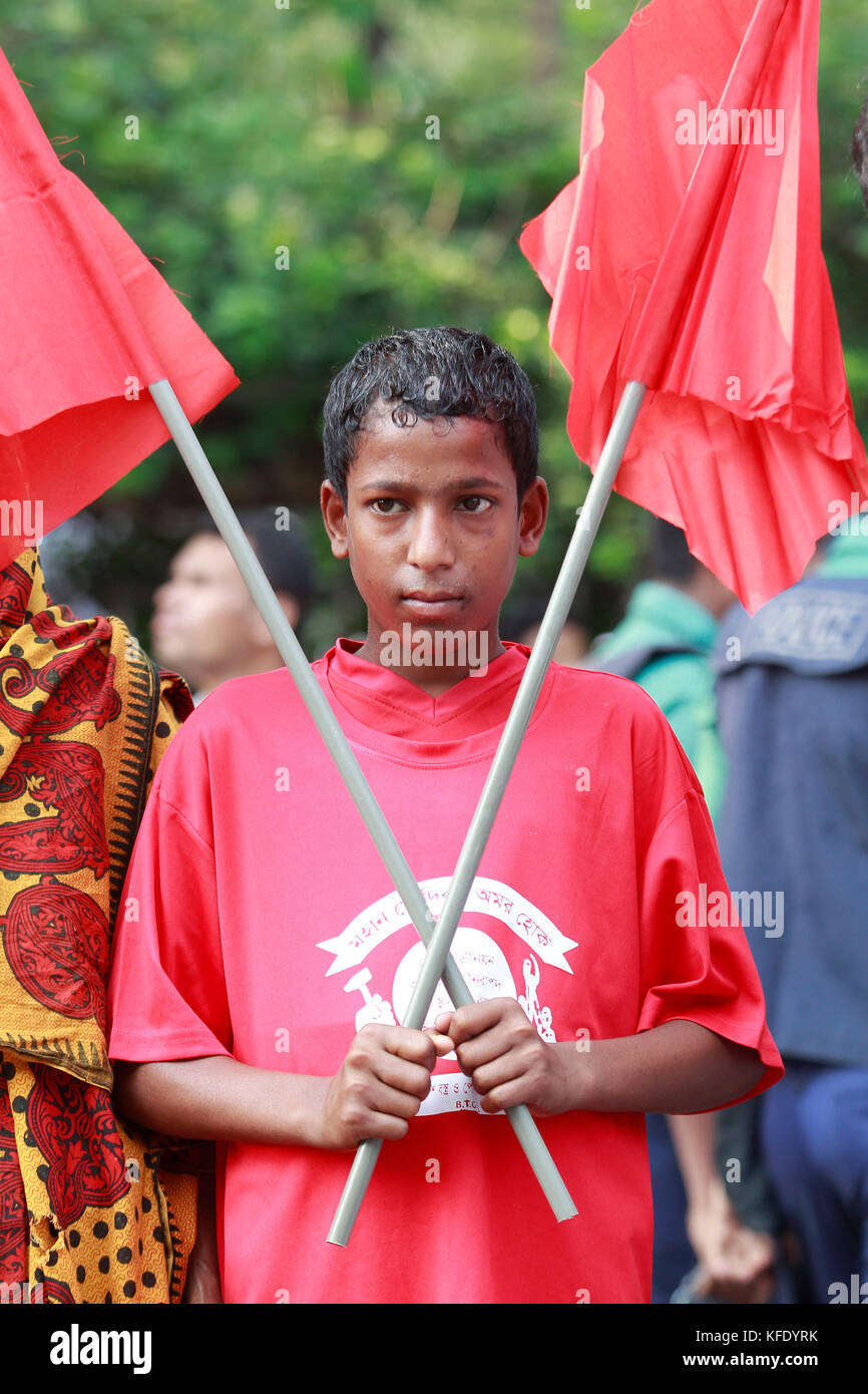A Bangladeshi boy holds red flag as he participates in a May Day rally ...