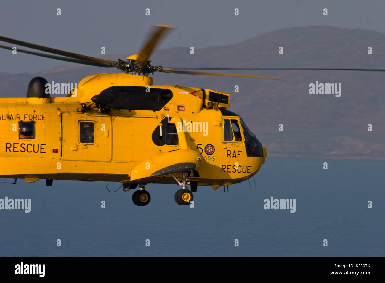 Yellow Sea King Helicopter flying off Baggy Point Croyde Devon Stock ...