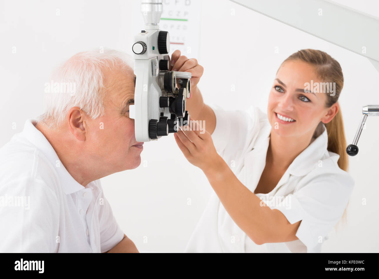 Happy Female Optometrist Doing Sight Testing For Patient In Clinic ...