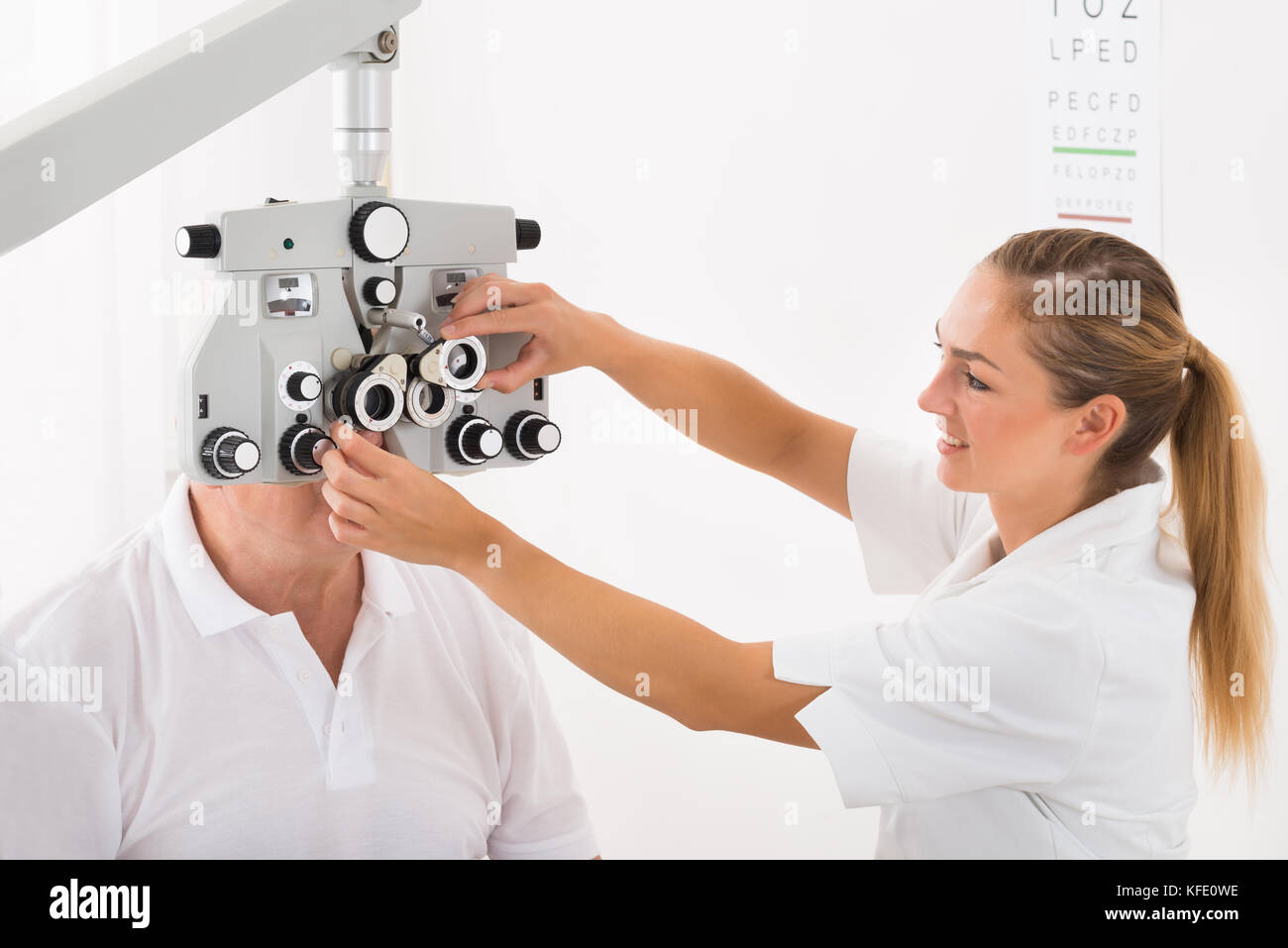 Happy Female Optometrist Doing Sight Testing For Patient In Clinic ...