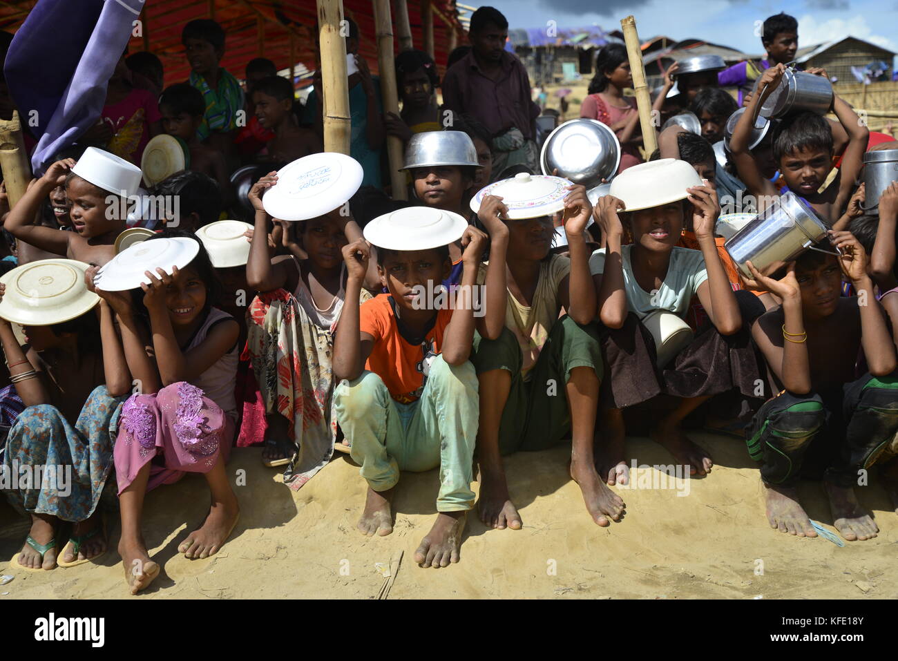 Rohingya refugee children wait to collect food at the palongkhali ...