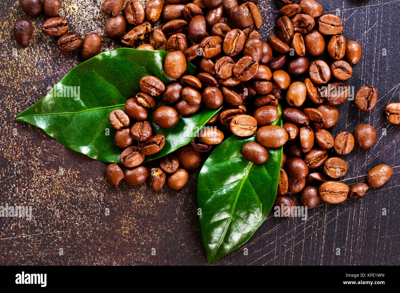 coffee beans and green leaf on a table Stock Photo - Alamy