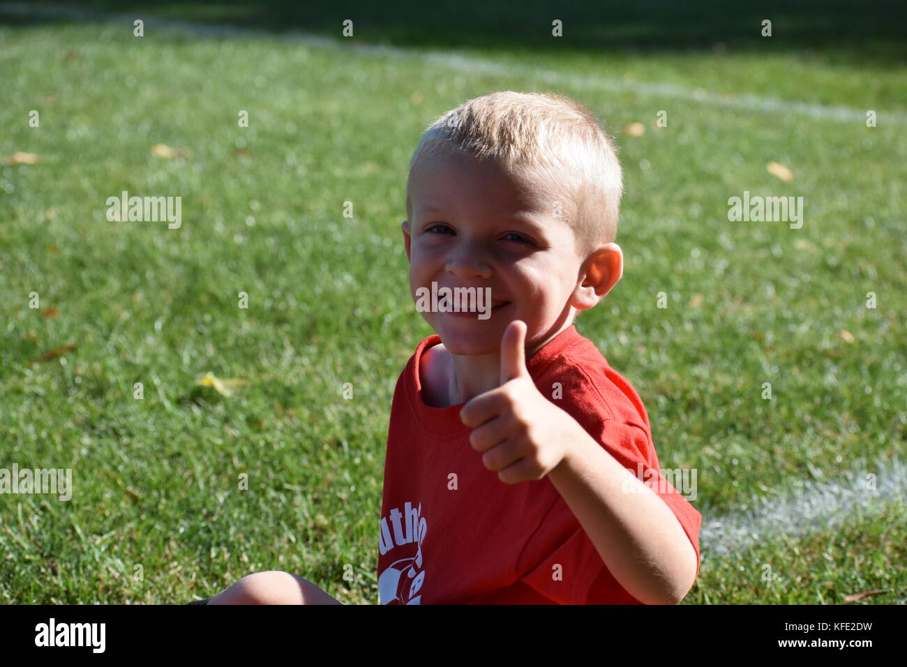 Cute boy giving thumbs up Stock Photo - Alamy