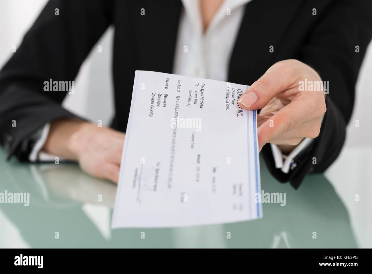 Close-up Photo Of Businesswoman Hand Giving Cheque Stock Photo - Alamy