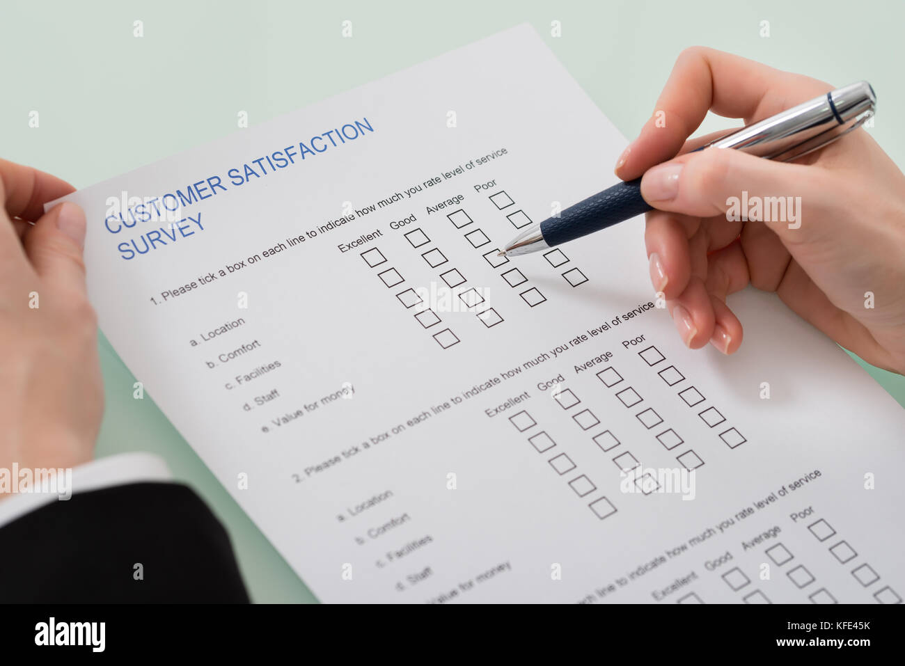 Close-up Of Woman Hand Filling Customer Satisfaction Form Stock Photo ...