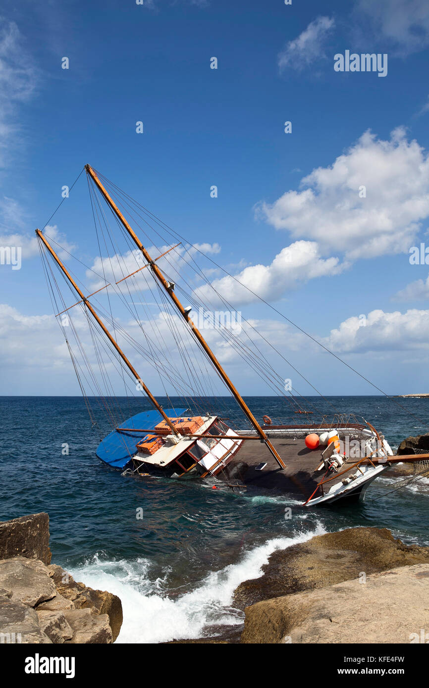 Schooner shipwrecked and beached on coastline rocks Stock Photo - Alamy