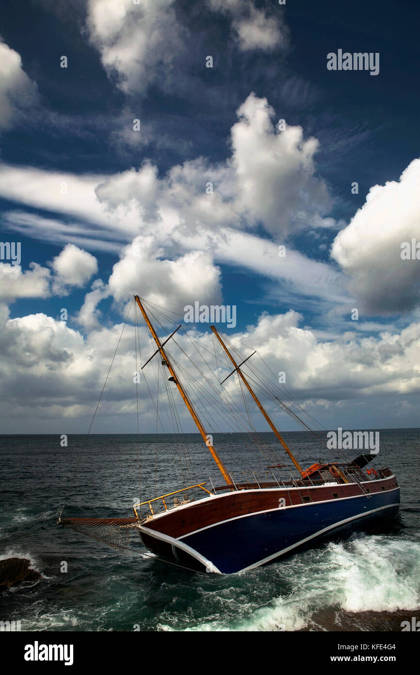 Schooner shipwrecked and beached on coastline rocks Stock Photo - Alamy