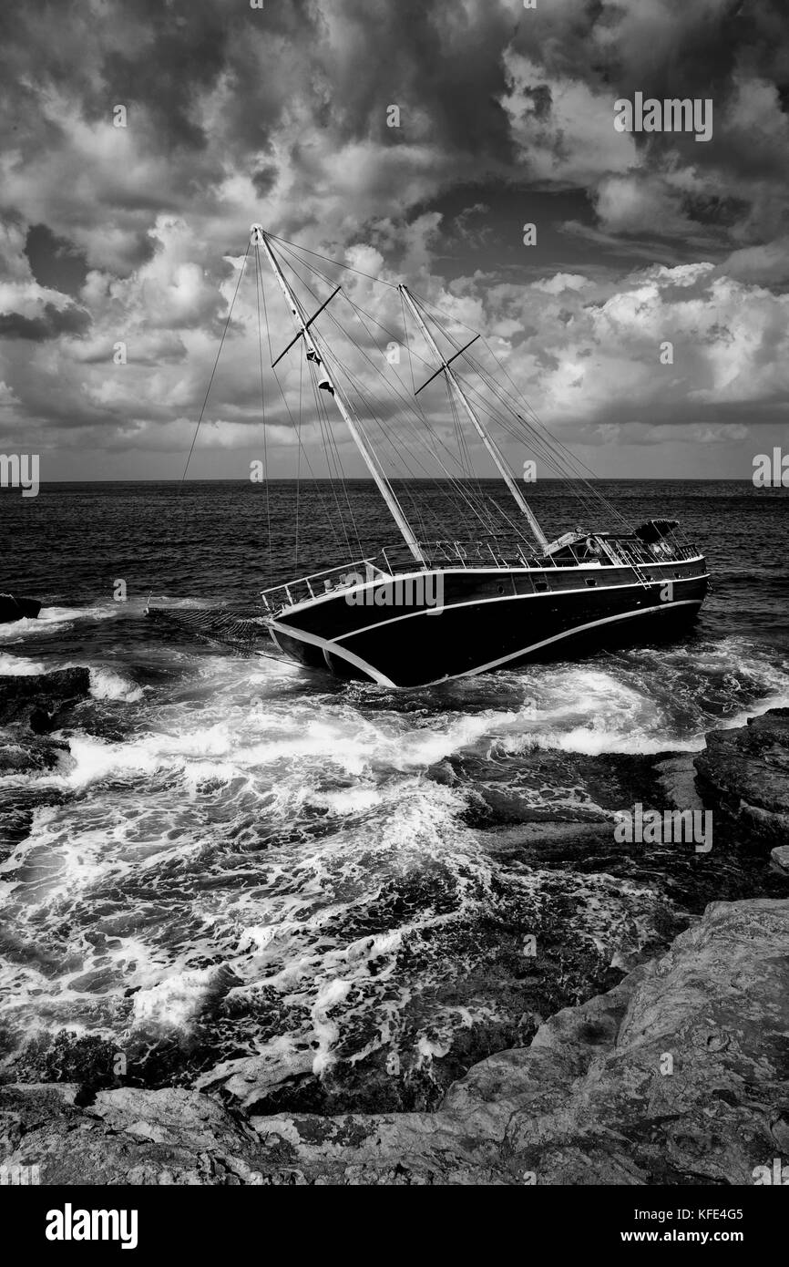 Schooner shipwrecked and beached on coastline rocks Stock Photo - Alamy