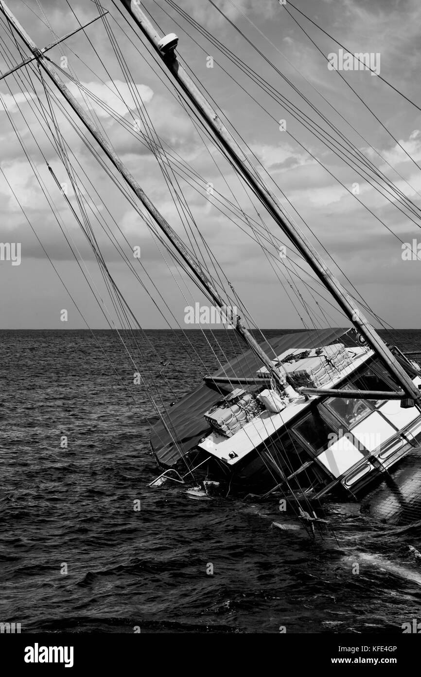 A schooner listing to its side and slowly sinking Stock Photo - Alamy