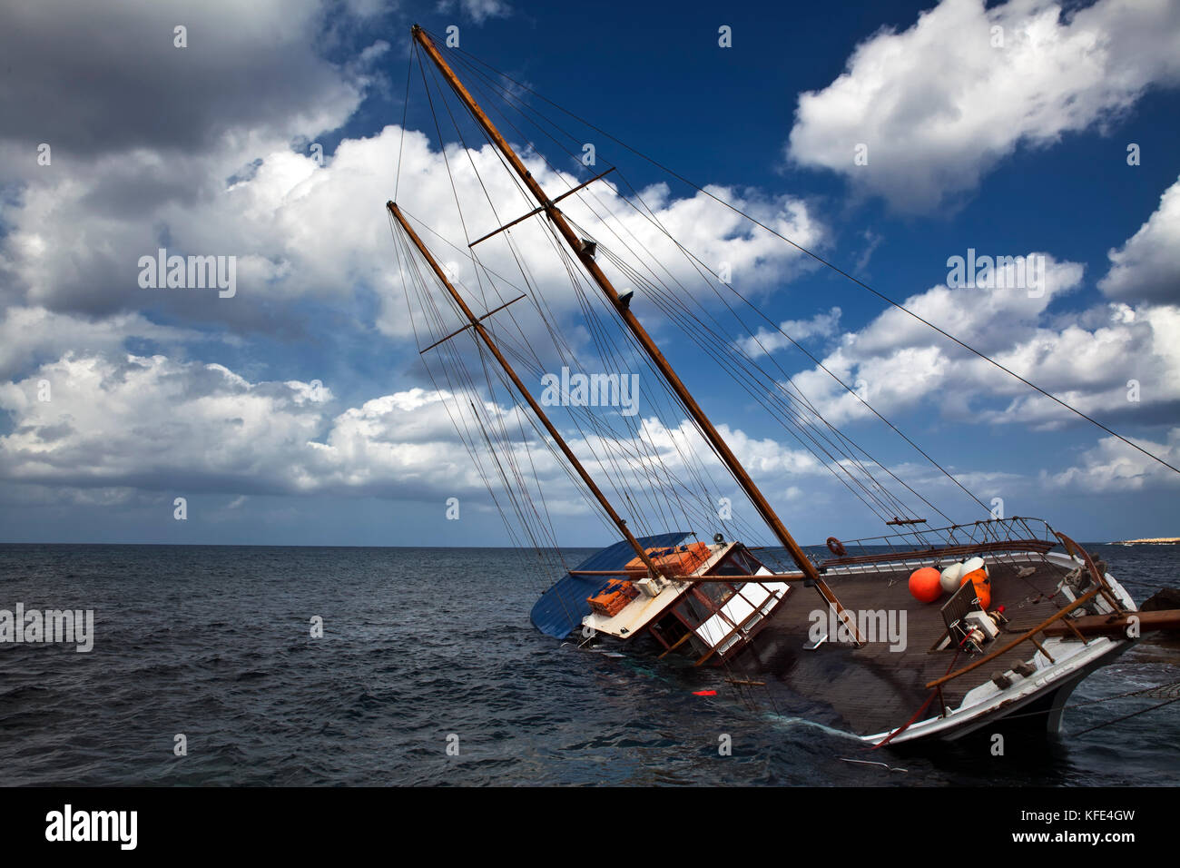 A schooner listing to its side and slowly sinking Stock Photo - Alamy