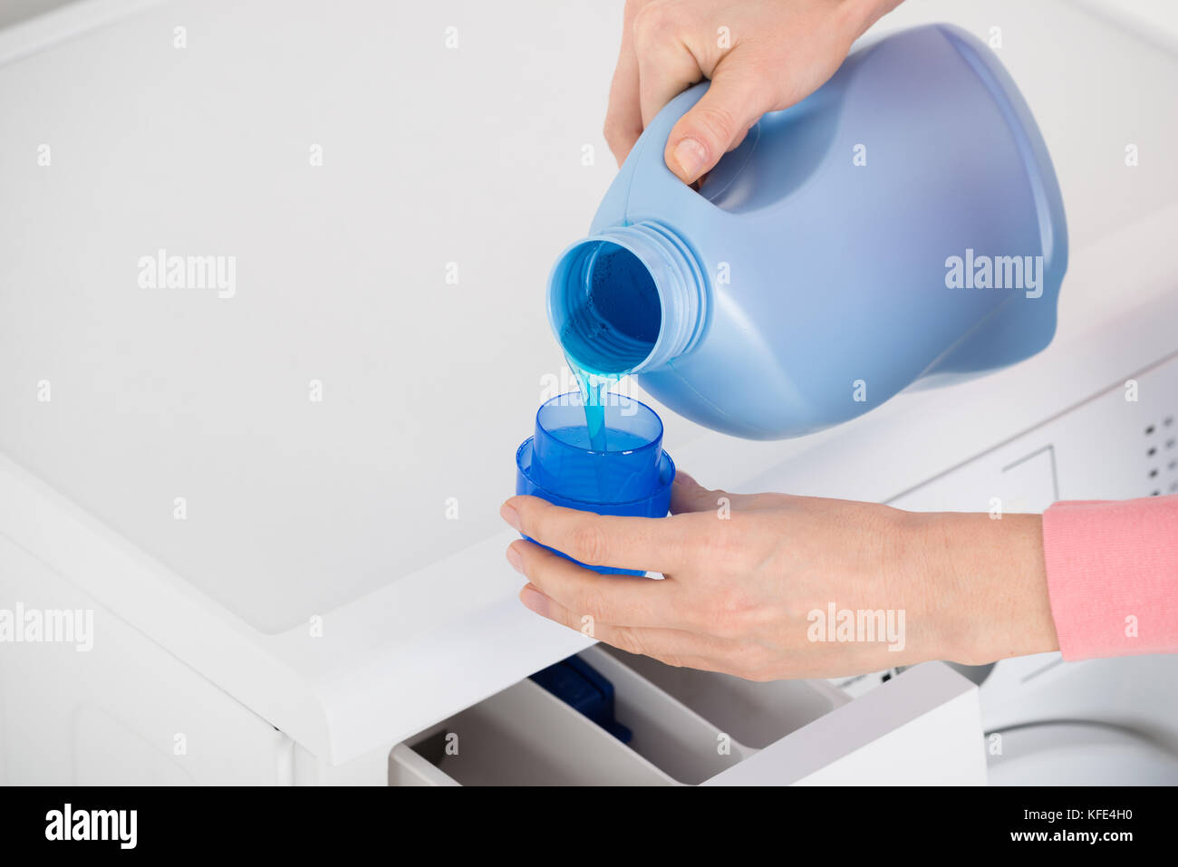 Close-up Of Female Hand Pouring Detergent In The Blue Bottle Cap Stock ...