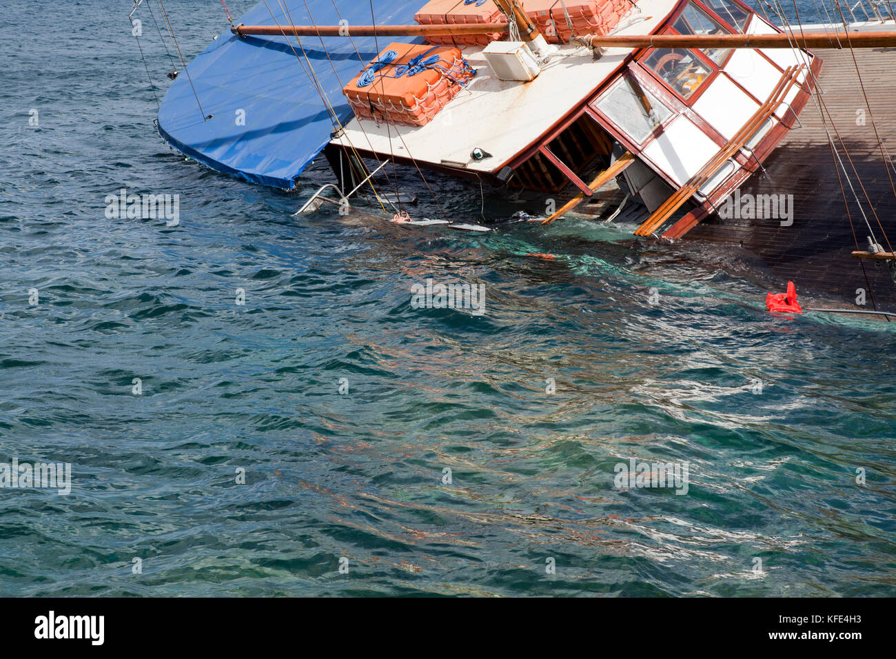 A schooner listing to its side and slowly sinking Stock Photo - Alamy